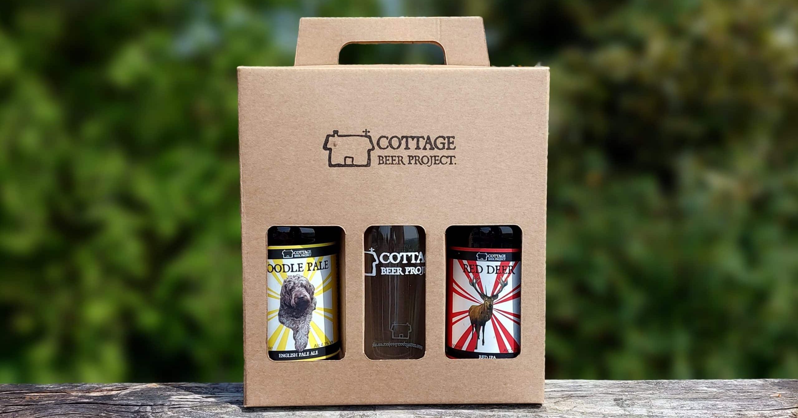 Two Cottage Beer Project beers and a branded pint glass